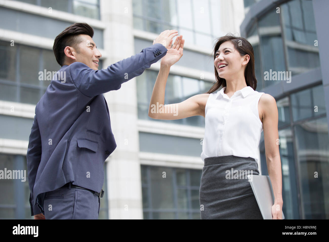 Business people high fiving other hi-res stock photography and images ...