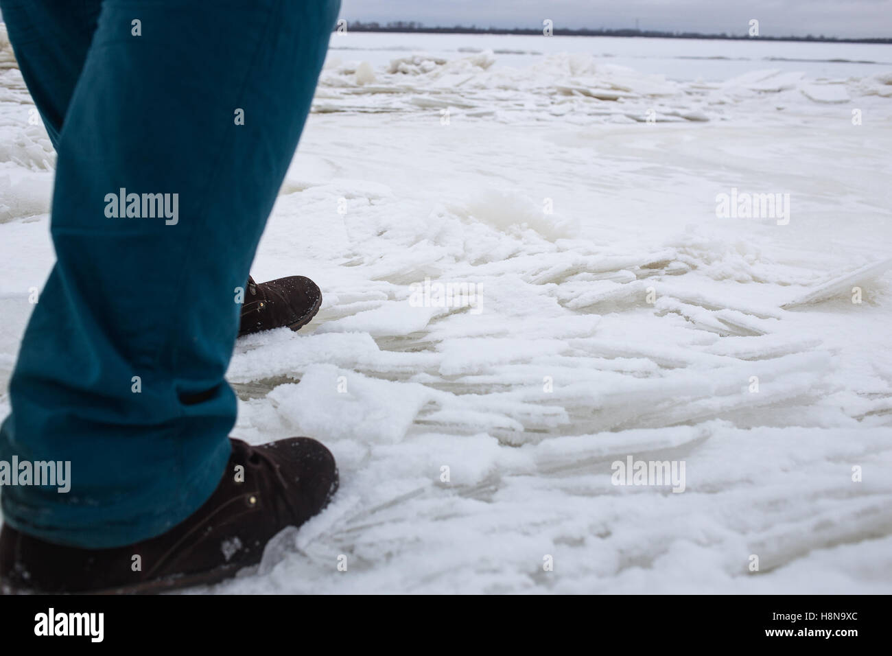 Man Comes On The Weak Bad River Ice. Concept danger falling through the ...