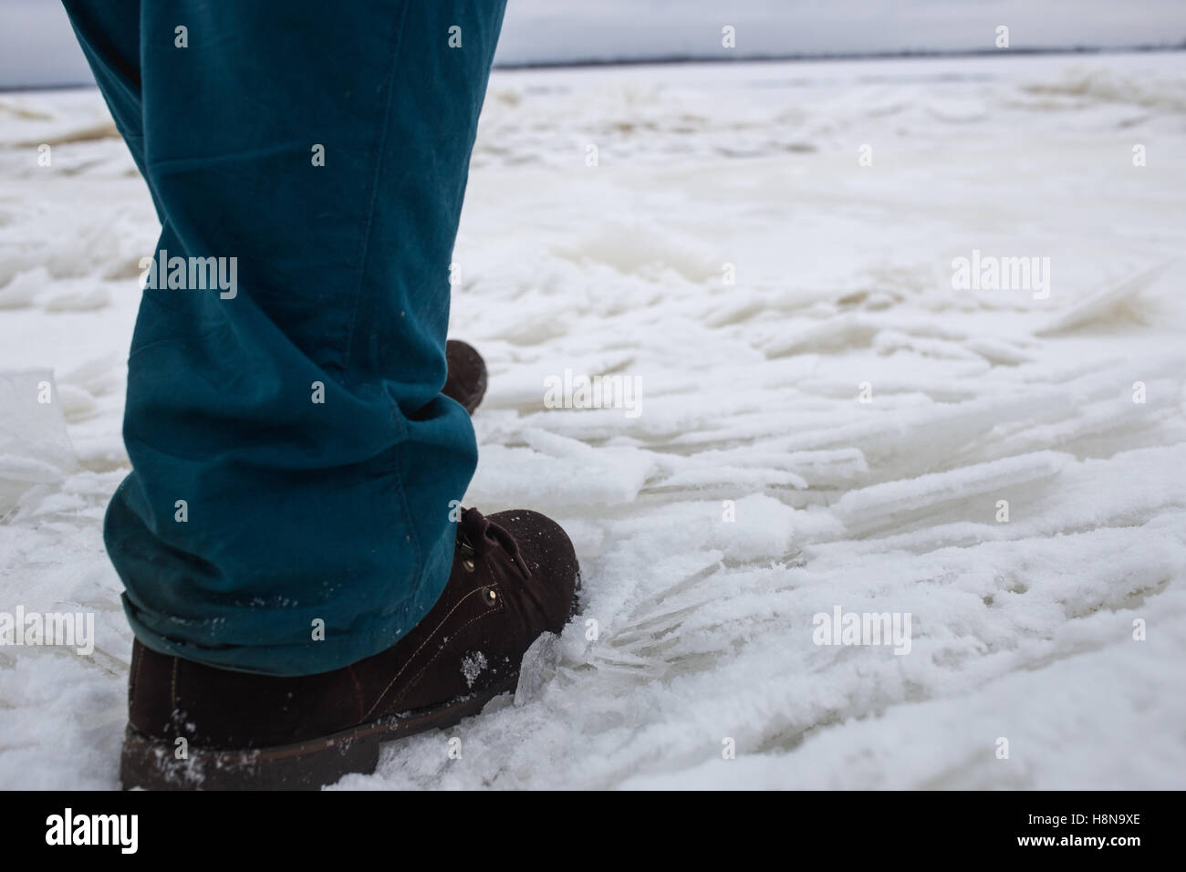 Man Comes On The Weak Bad River Ice. Concept danger falling through the ...