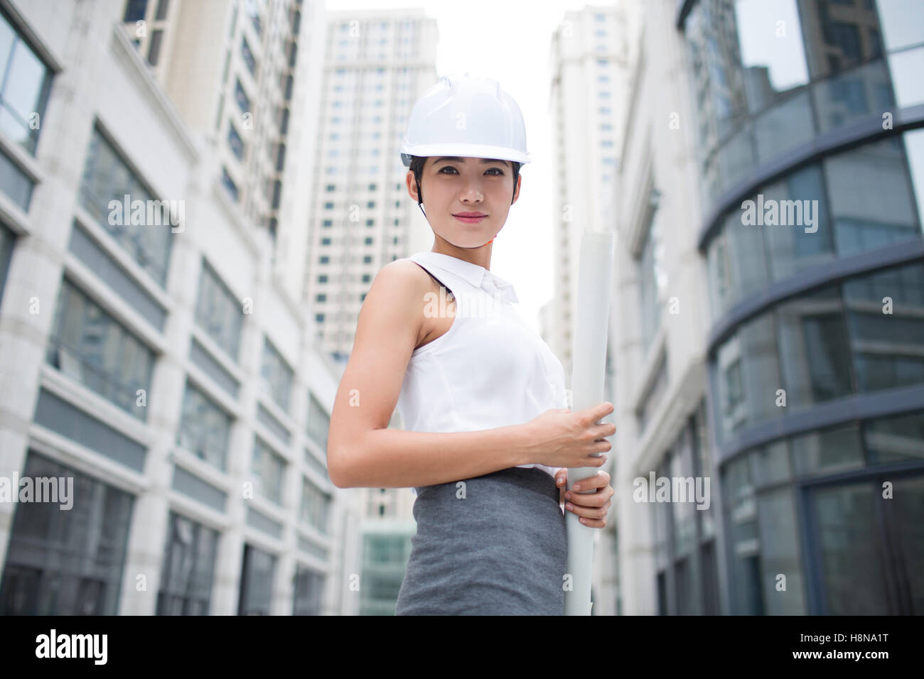 Portrait of Chinese female architect with blueprint outdoors Stock ...