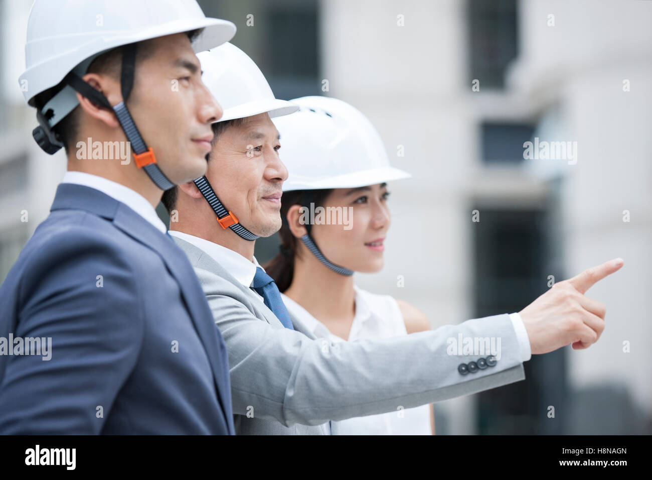 Confident Chinese architects talking outdoors Stock Photo - Alamy