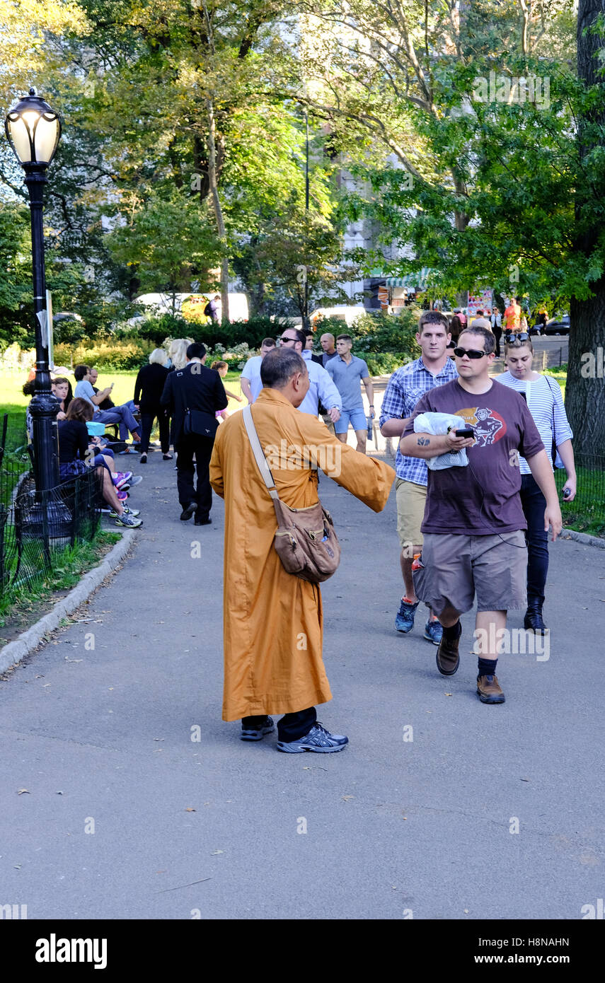 Buddhist monk seen handing out charity information to members of the ...