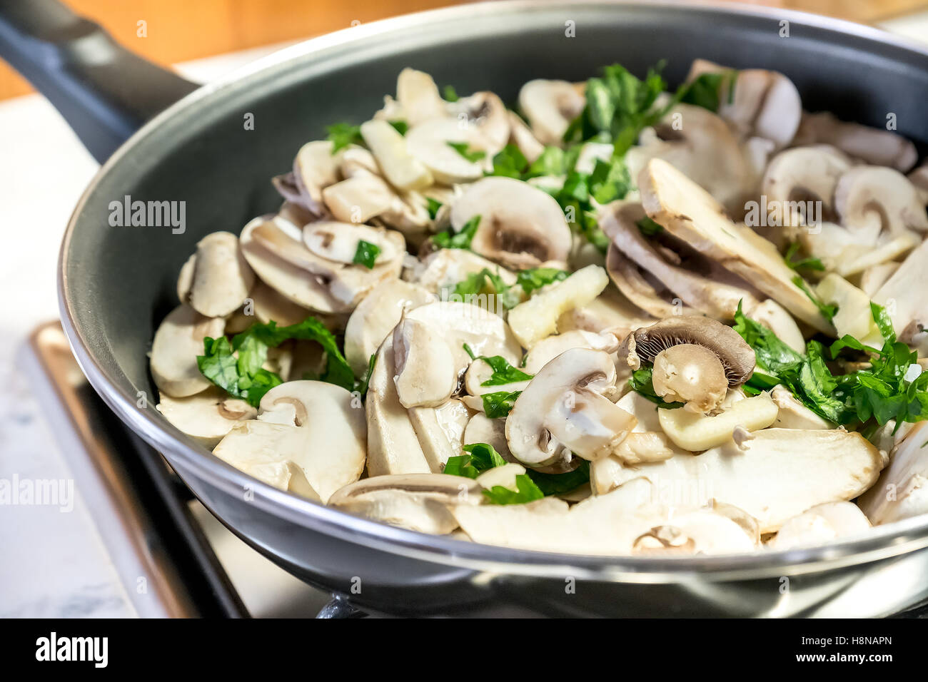 Mushroom slice pan cooking raw closeup Stock Photo - Alamy