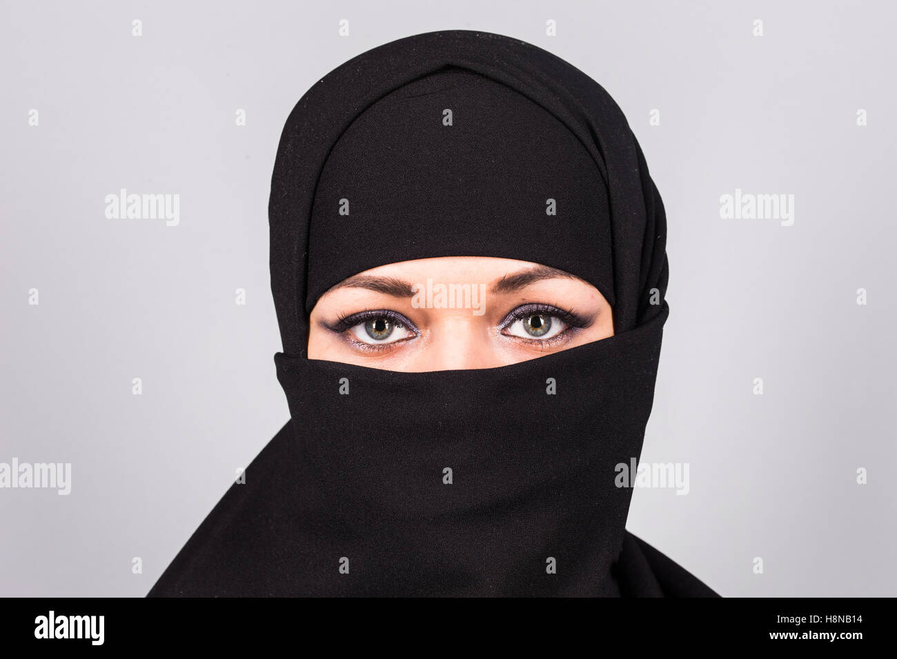 Young woman wearing niqab on background Stock Photo - Alamy