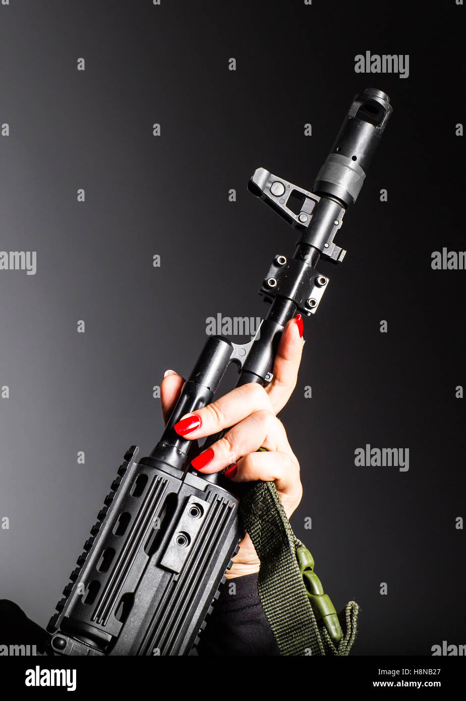 Close up of woman's hand holding army weapon machine gun AKS Stock ...