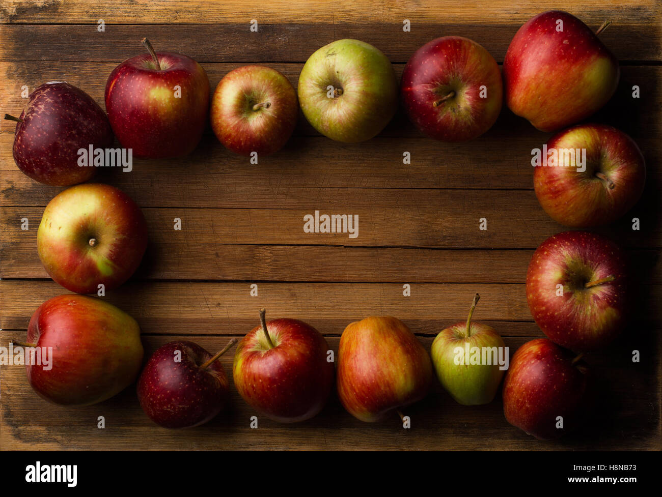 Horizontal top view of organic small raw apples on vintage wood board ...