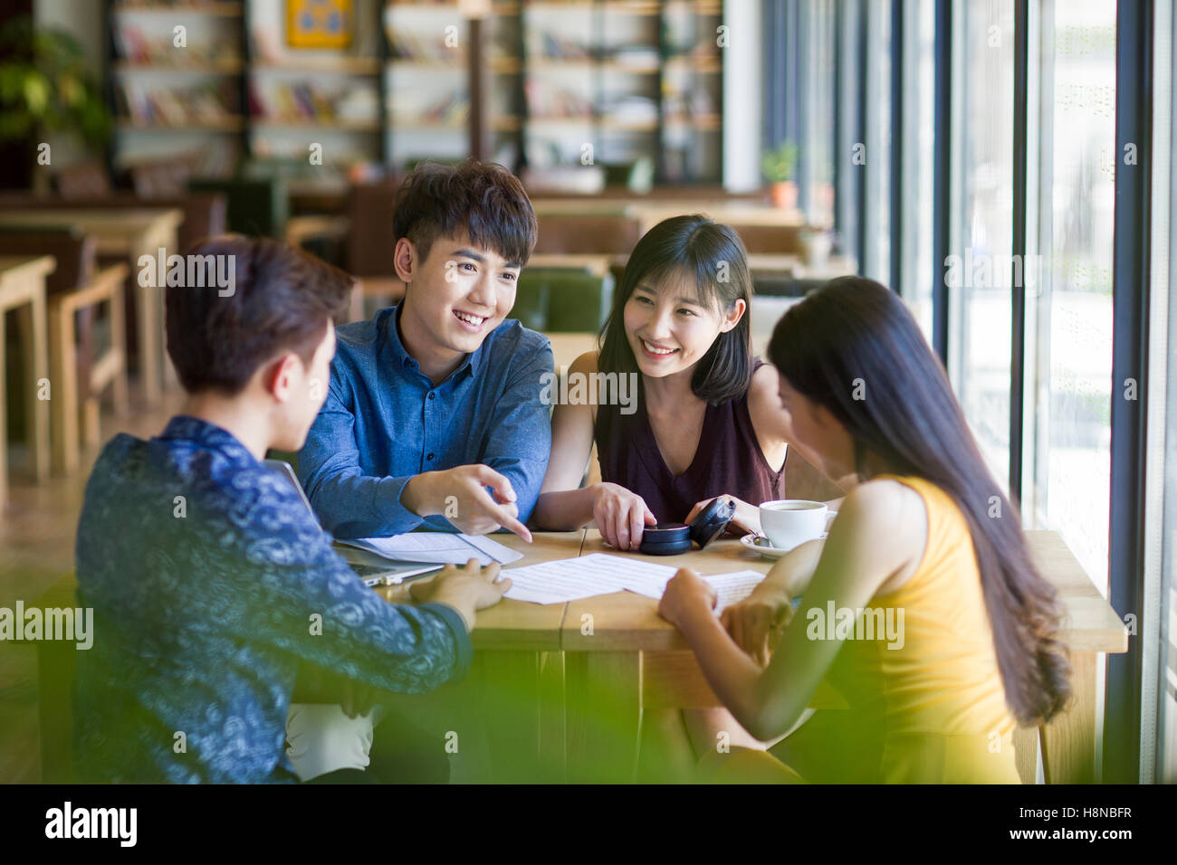 Young Chinese friends talking about music in cafe Stock Photo - Alamy