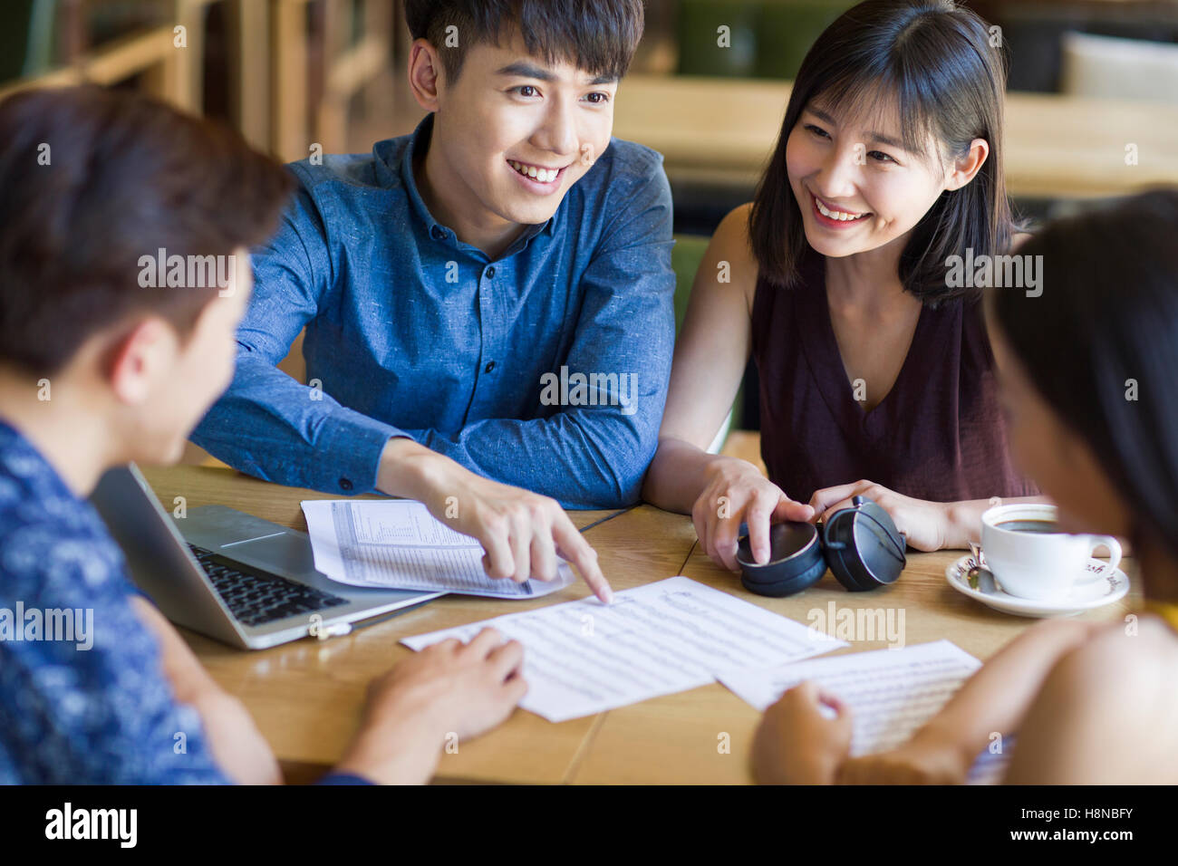 Young Chinese friends talking about music in cafe Stock Photo - Alamy
