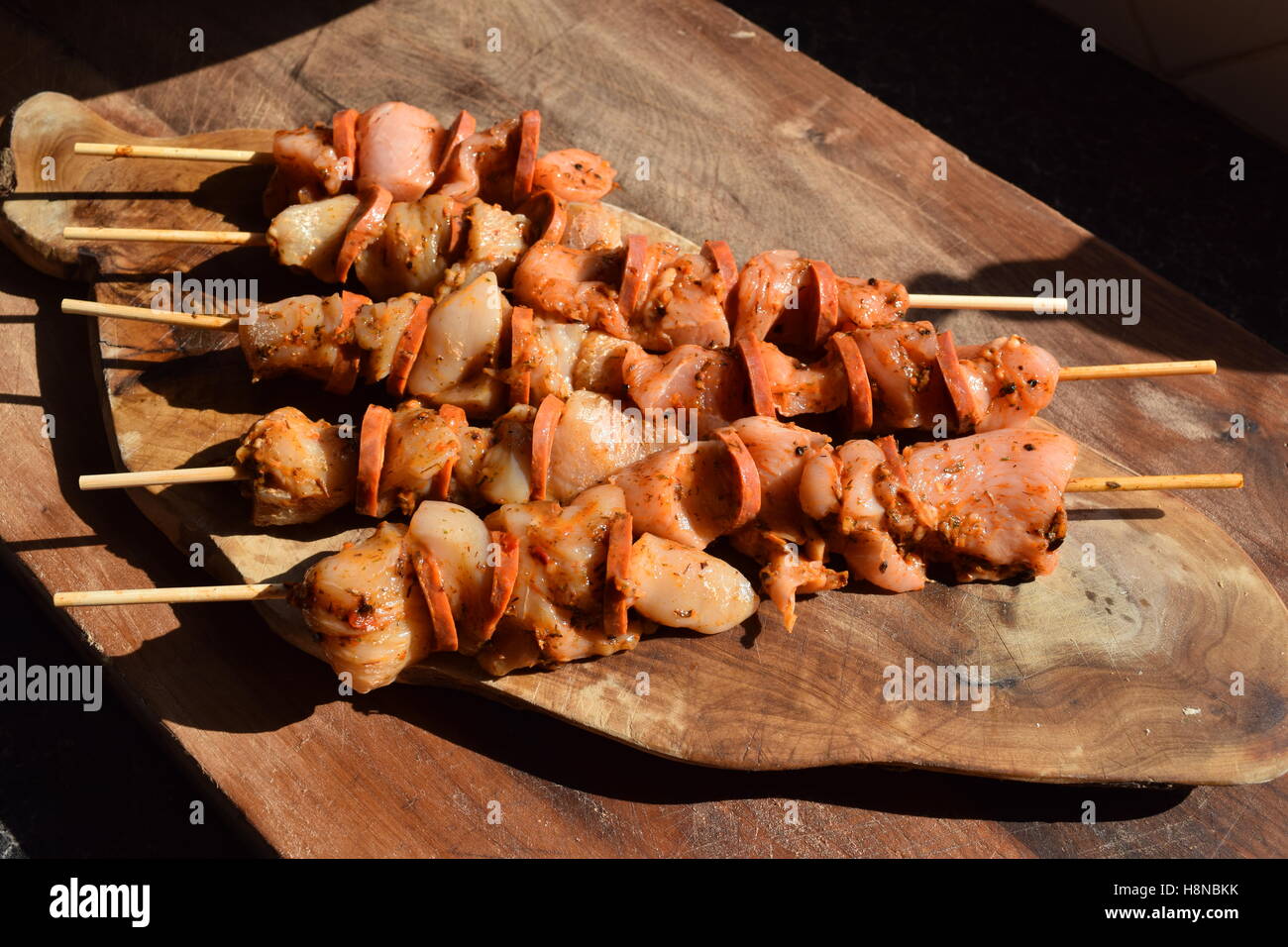 Raw seasoned chicken chunks on skewers Stock Photo - Alamy