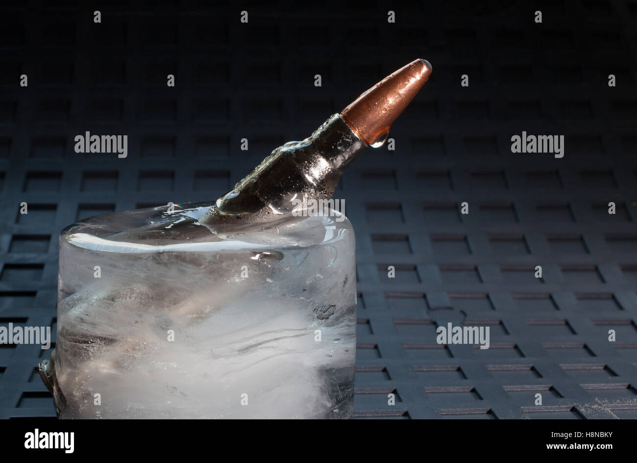Drop of water coming of ammunition trapped in ice Stock Photo - Alamy