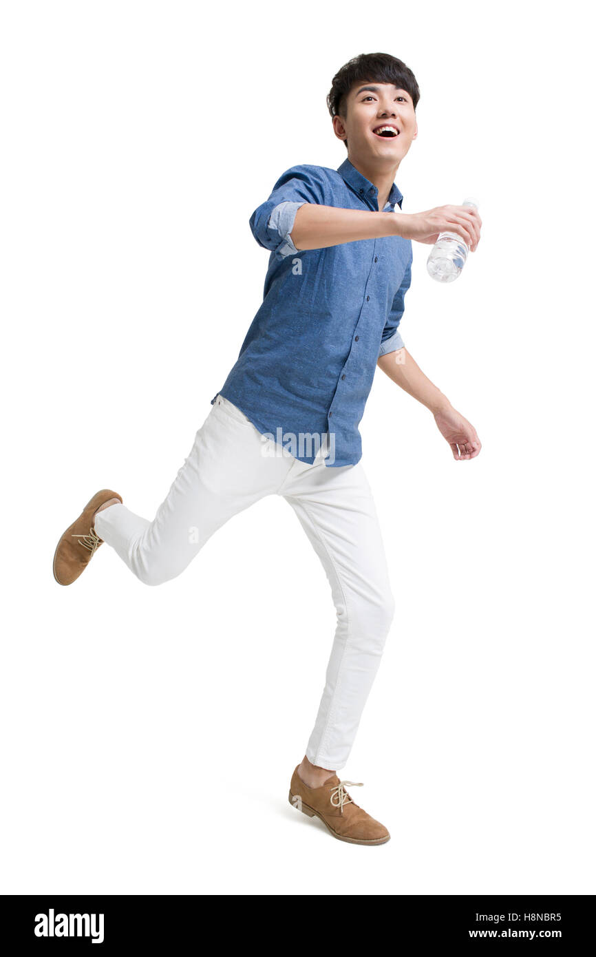 Happy young Chinese man running with a bottle of water Stock Photo - Alamy