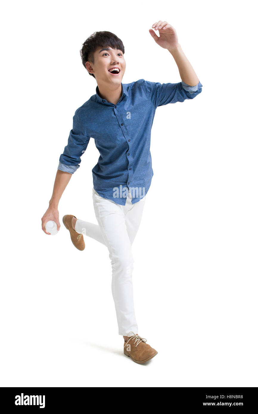 Happy young Chinese man running with a bottle of water Stock Photo - Alamy
