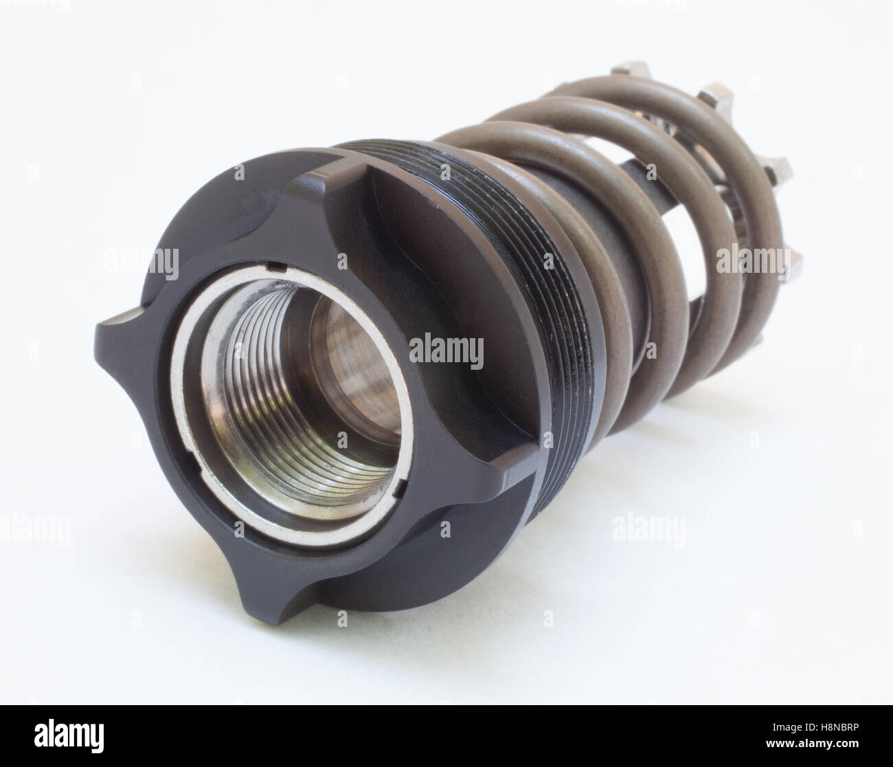 Springed valve that allows a suppressor to rotate on a white background ...