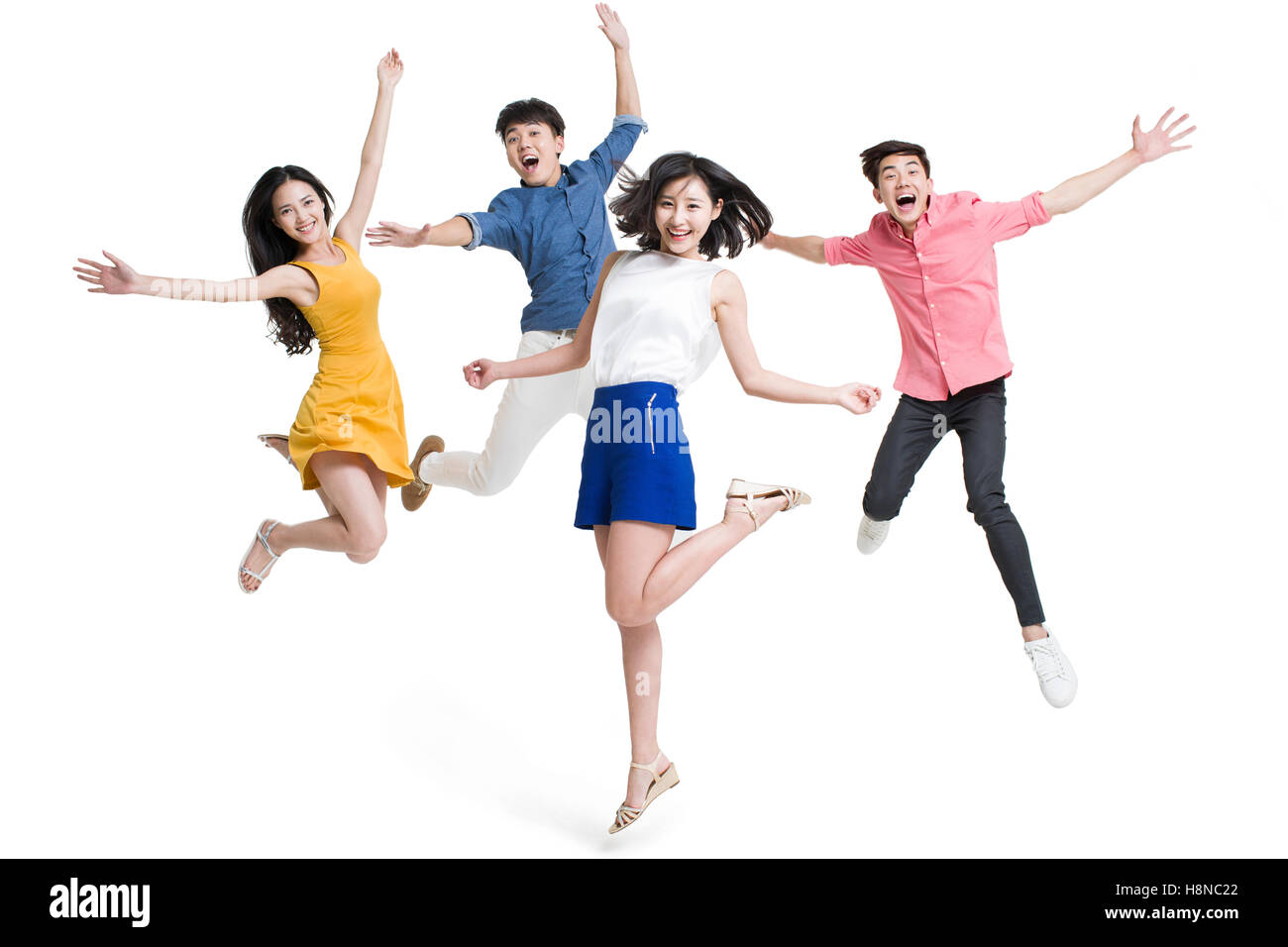 Happy young Chinese friends jumping Stock Photo - Alamy