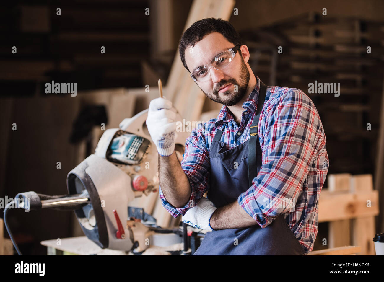 Master sells its own products. Male carpenter have an idea at workshop ...