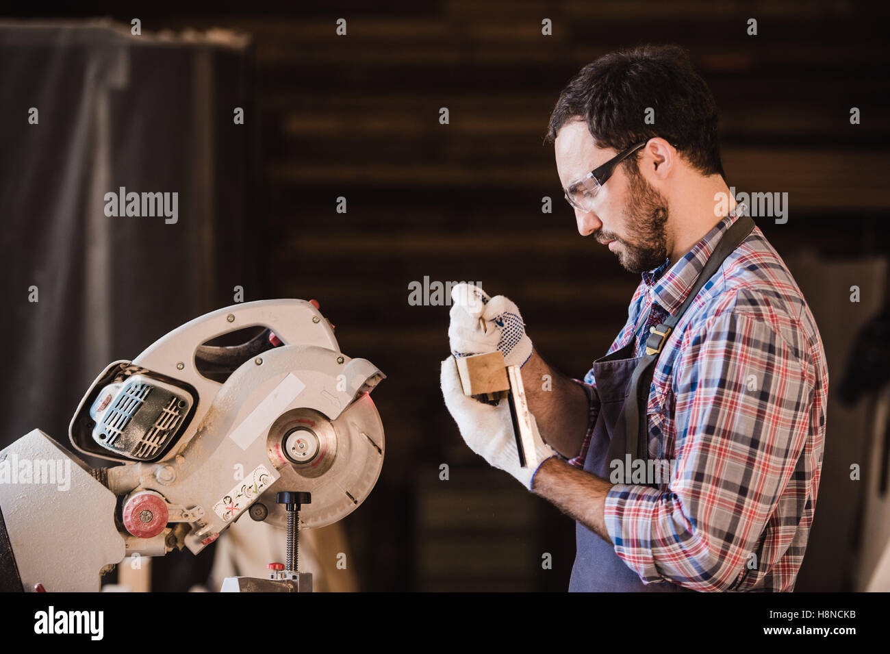 profession, carpentry, woodwork people concept - carpenter with wood ...