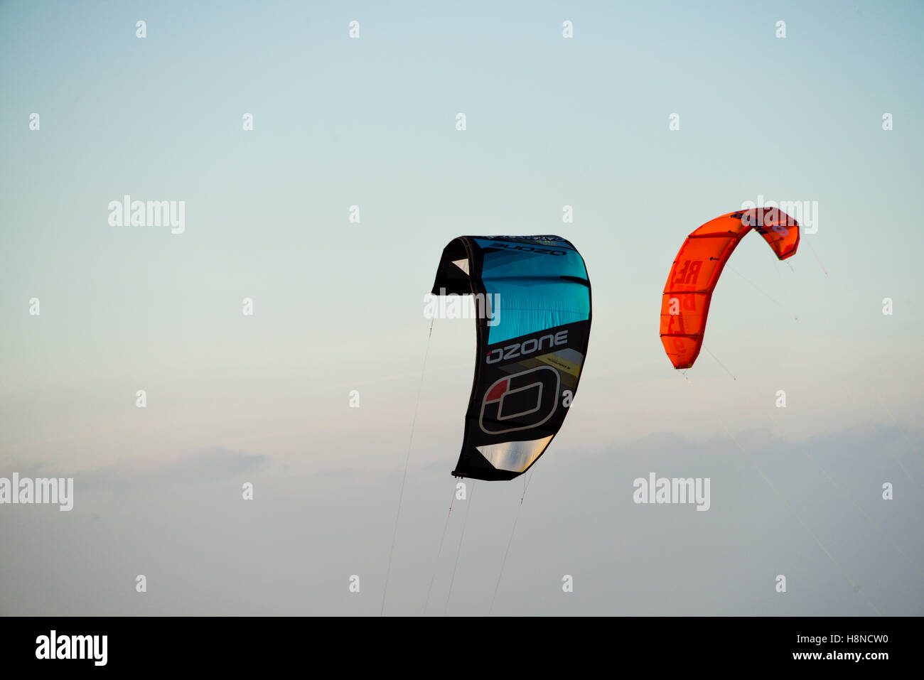 A pair of kite surfing kites in the evening sky on Erice beach, Sicily ...