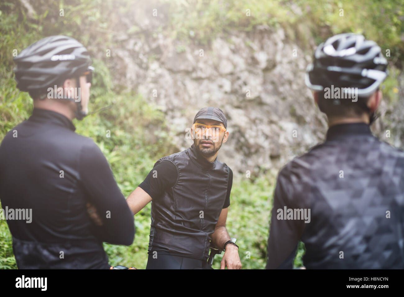 Three cyclists taking a break in Cheddar George Stock Photo - Alamy