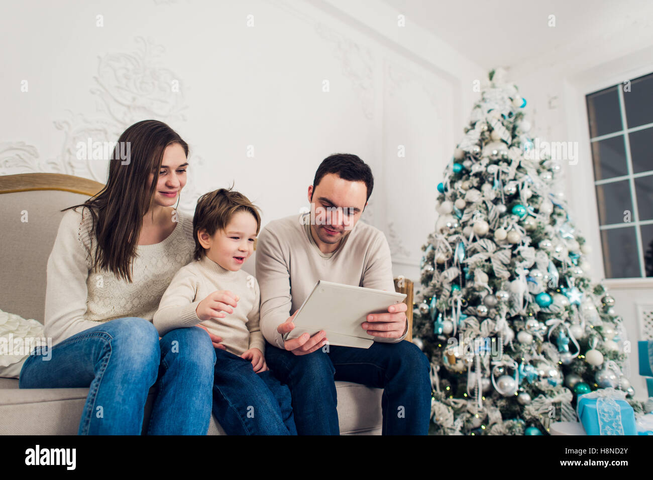 Family playing video game on tablet pc Stock Photo - Alamy