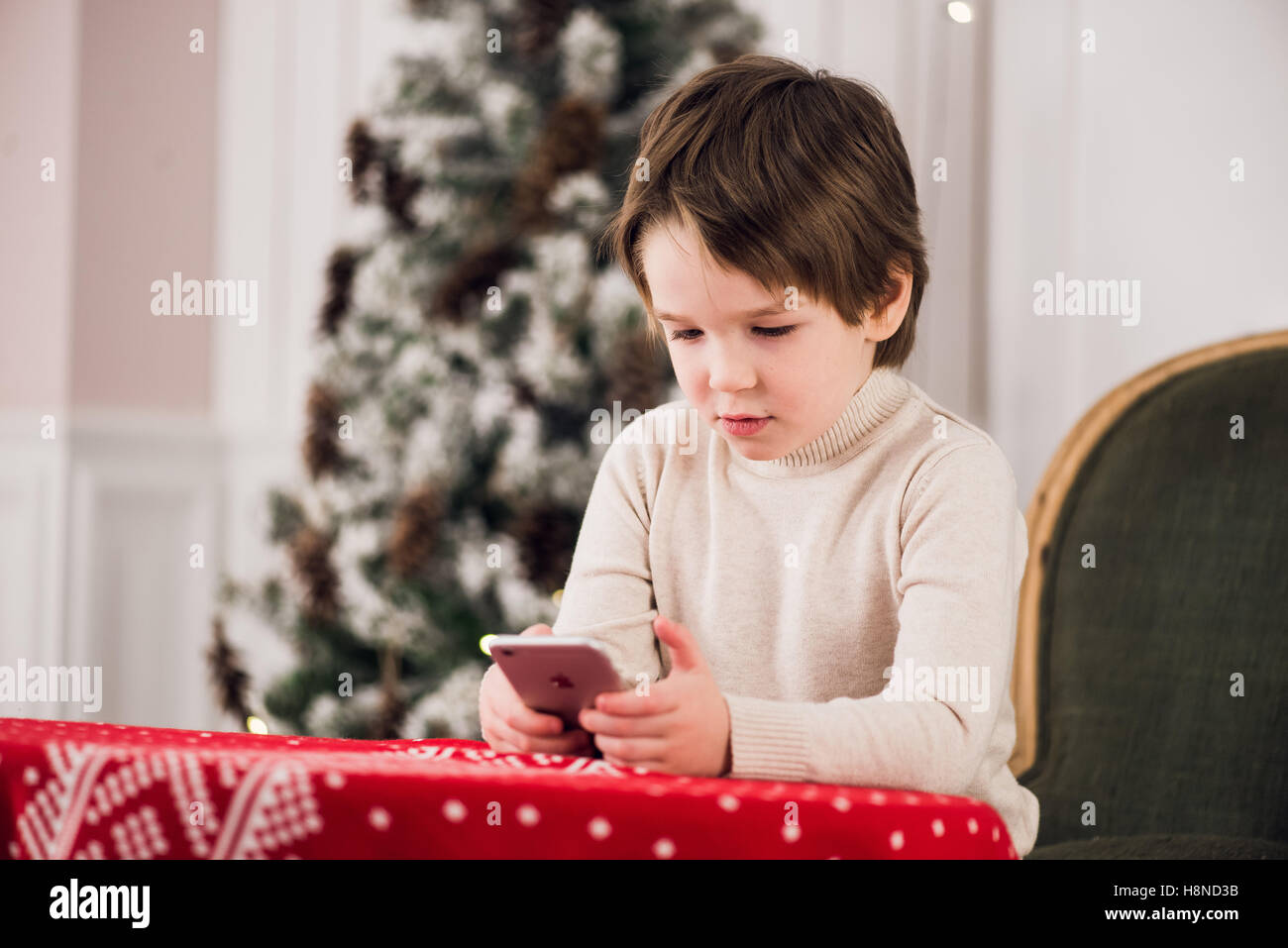 Little happy boy at home using smart phone Stock Photo - Alamy