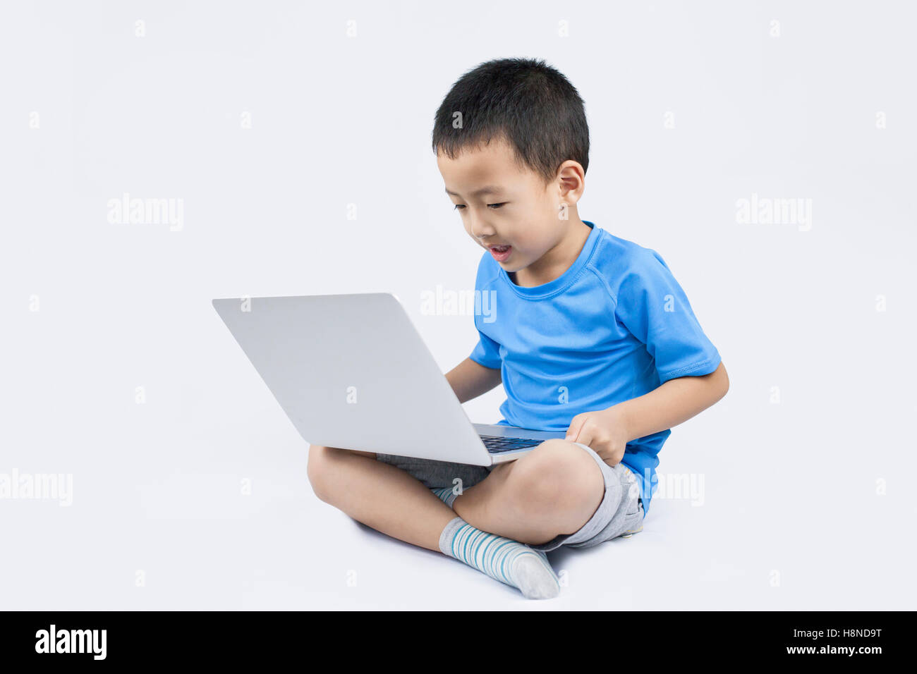 Happy little Chinese boy using a laptop Stock Photo - Alamy