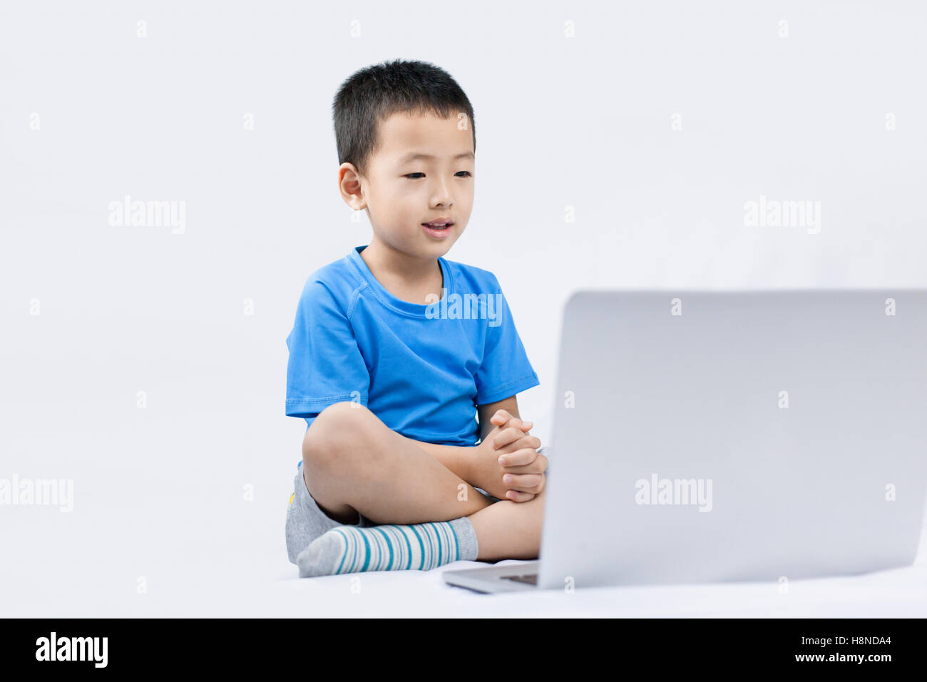 Happy little Chinese boy using a laptop Stock Photo - Alamy