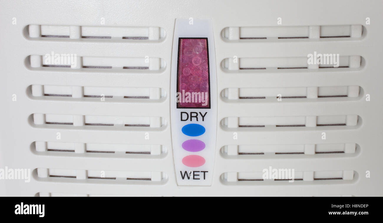 Container with a drying agent inside that changes color when saturated ...