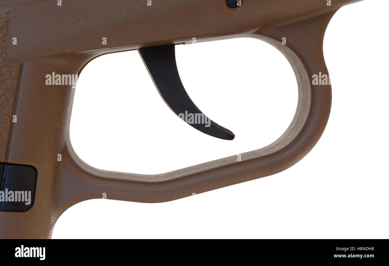 Black trigger on a brown polymer handgun on white Stock Photo - Alamy