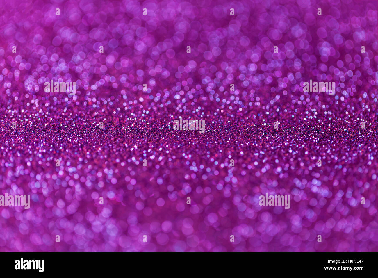 Purple sparkling background from small sequins, closeup. Brilliant and ...