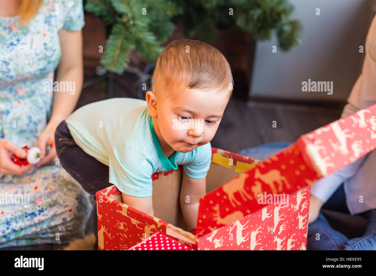 Young Baby Boy Opening a Gift Box Stock Photo - Alamy