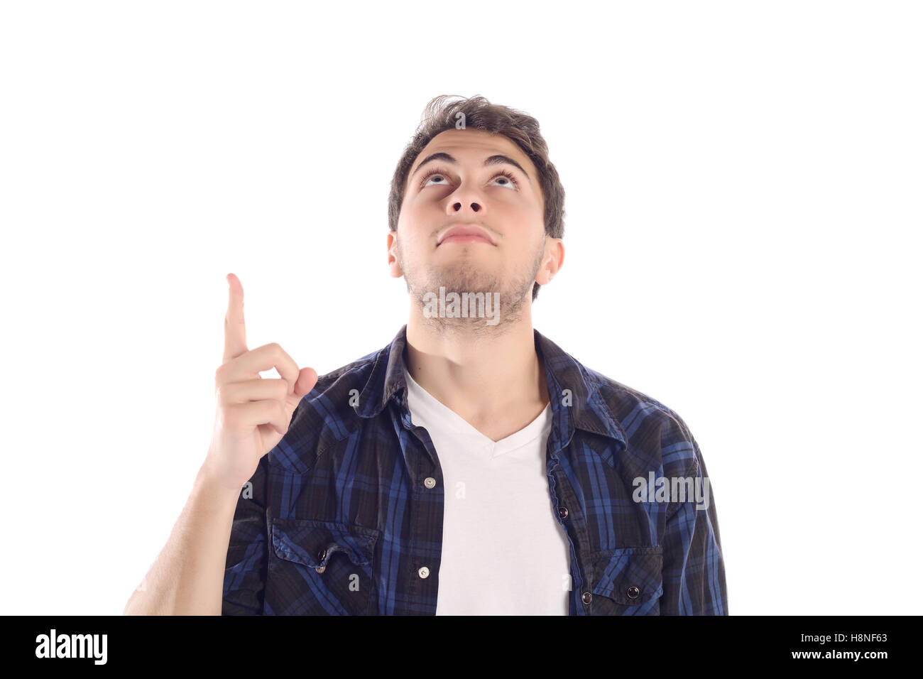 Portrait of attractive young man pointing up. Isolated white background ...