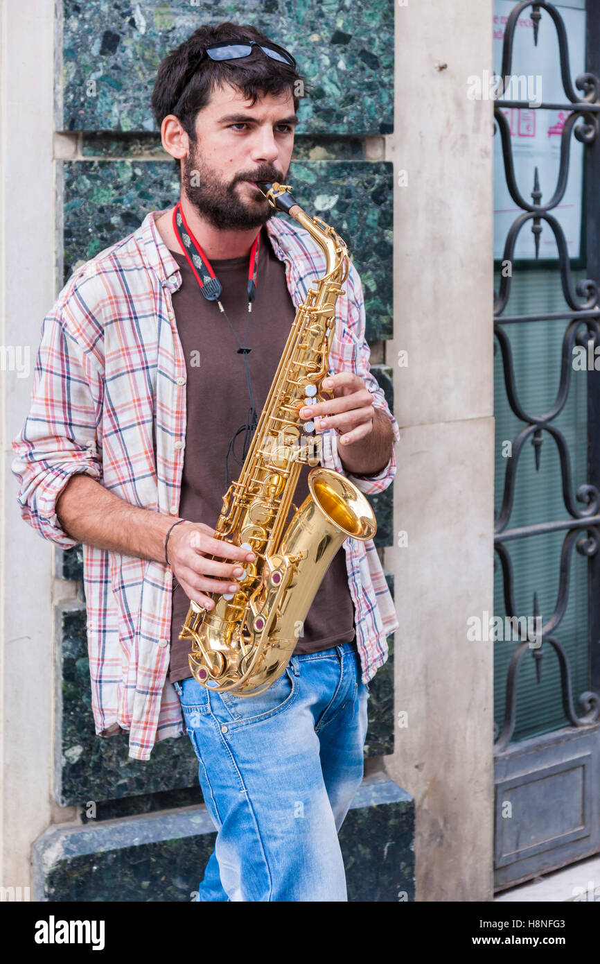 Busker playing a Saxophone on Av. de la Constitución, Seville, Spain ...