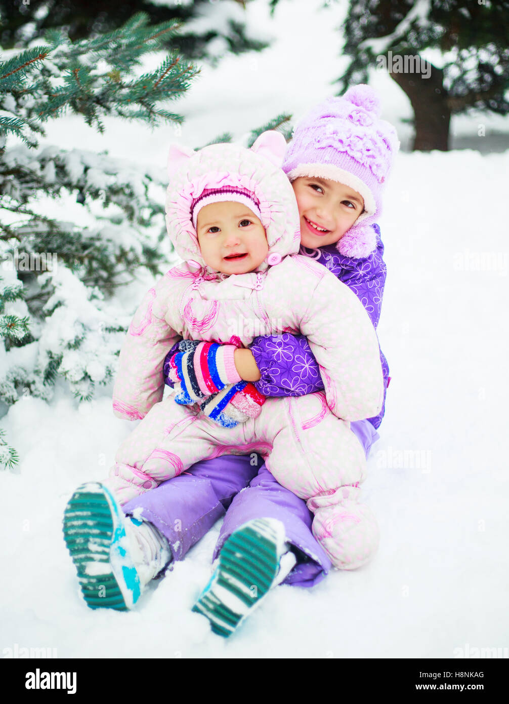 two sisters outdoor in the winter park Stock Photo - Alamy