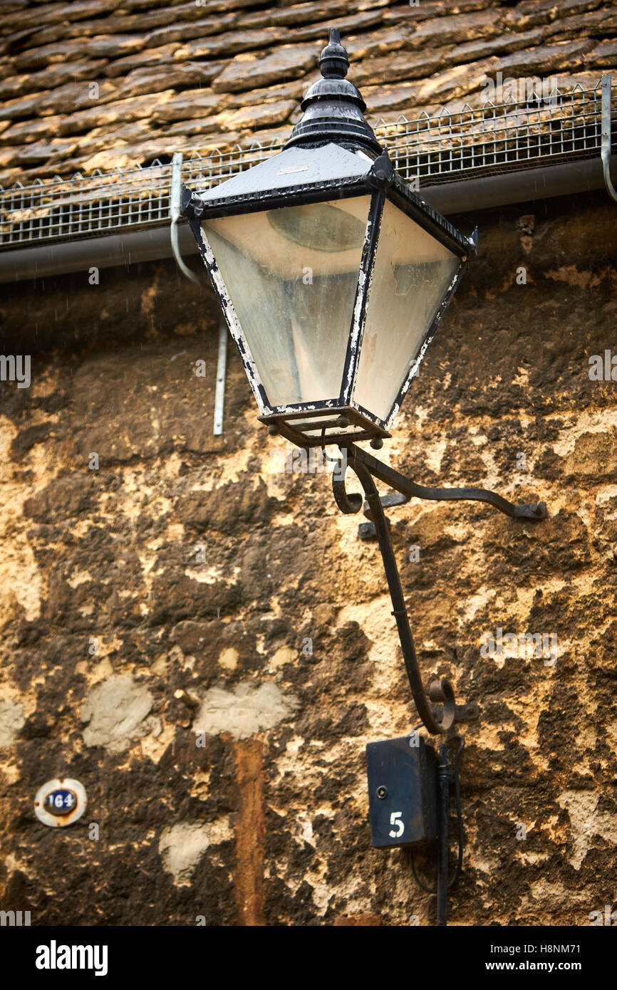 A street lamp on a building wall Stock Photo - Alamy
