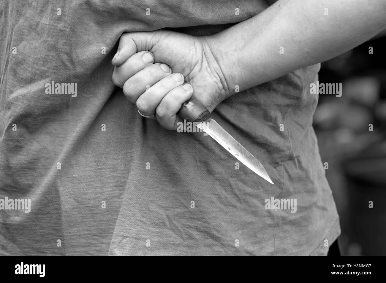Knife Behind Back Stock Photo - Alamy