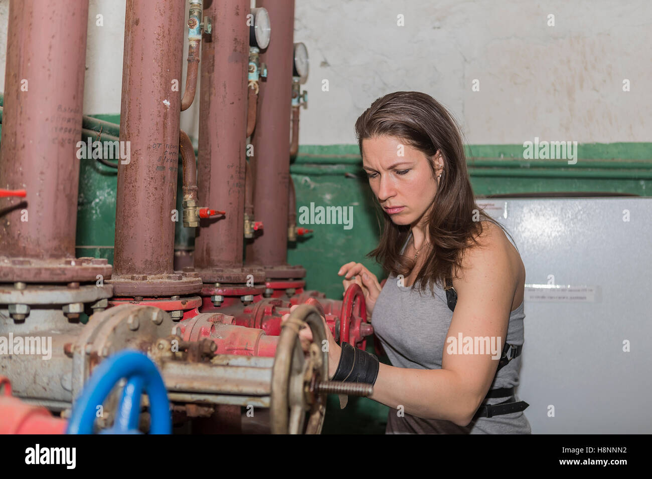 Woman working in the boiler room Stock Photo - Alamy