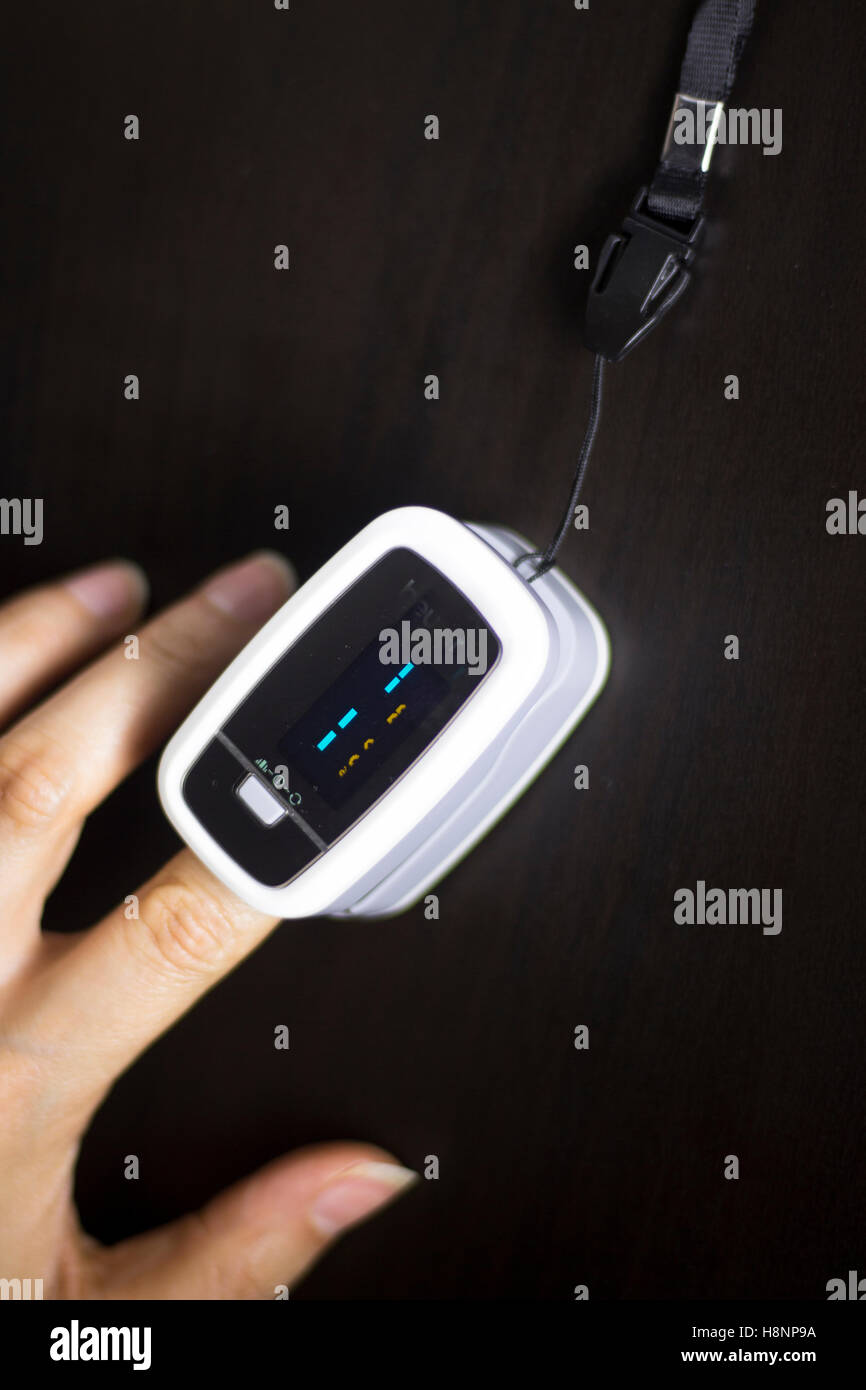 Portable hand held domestic cardiac finger pulse rate meter to show ...