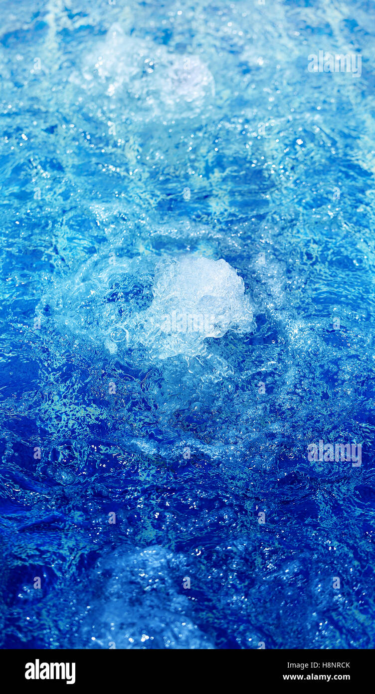 Beautiful little fountain from the blue water Stock Photo - Alamy