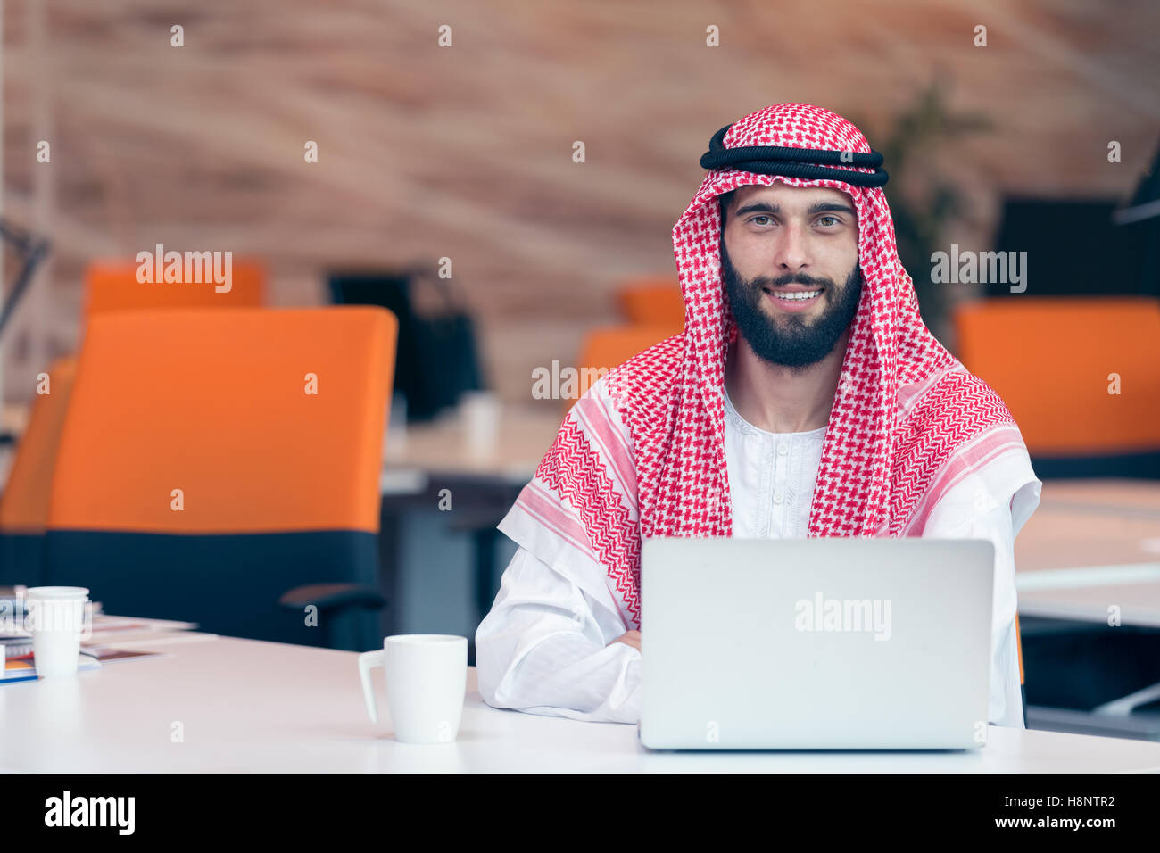 Arabian businessman working in modern startup office Stock Photo - Alamy