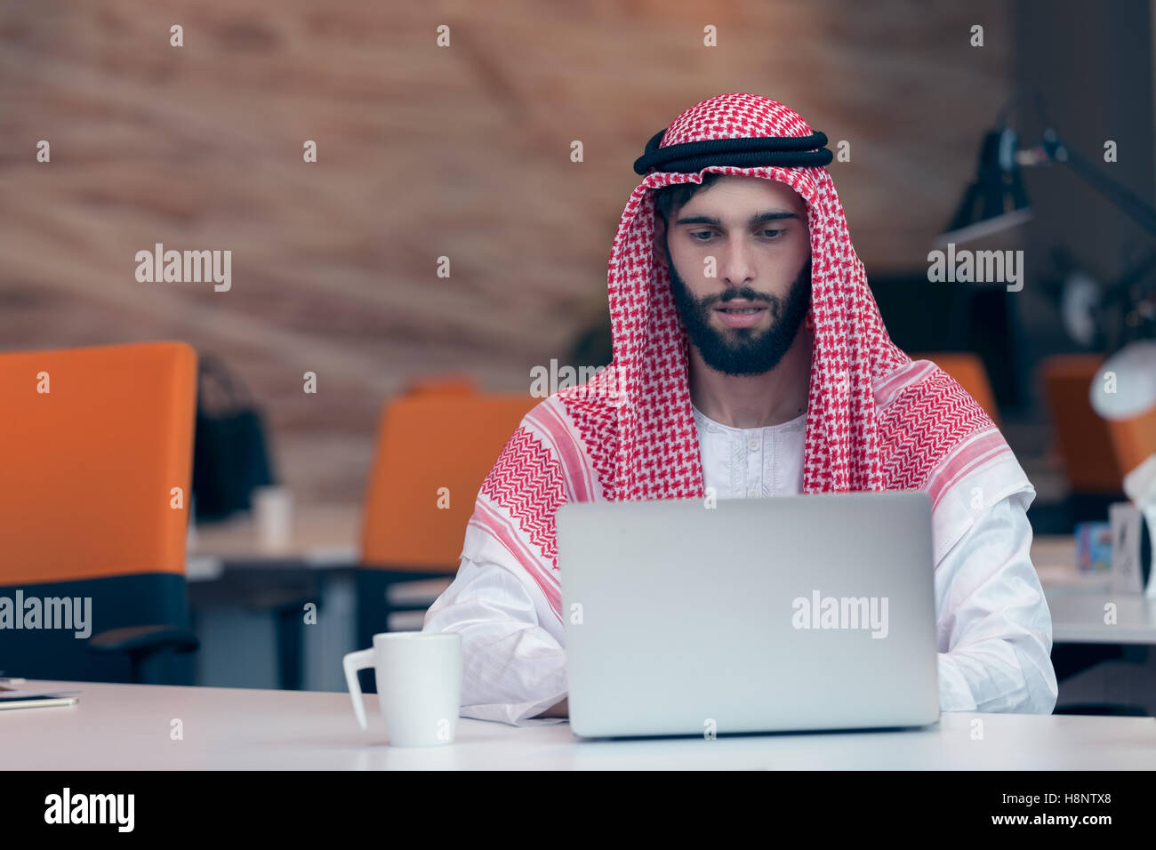 Arabian businessman working in modern startup office Stock Photo - Alamy