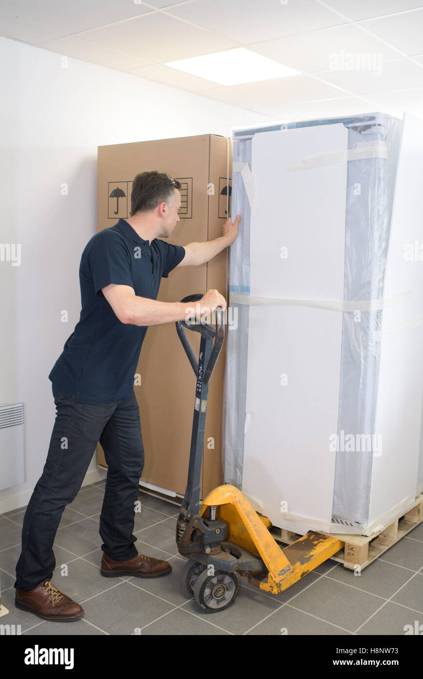mature man moving huge cartons with trolley Stock Photo - Alamy