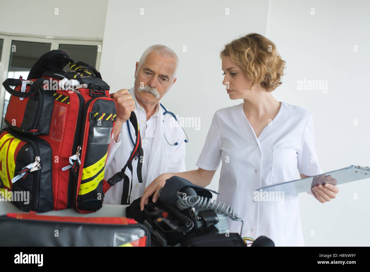 ambulance team preparing gear before intervention Stock Photo - Alamy