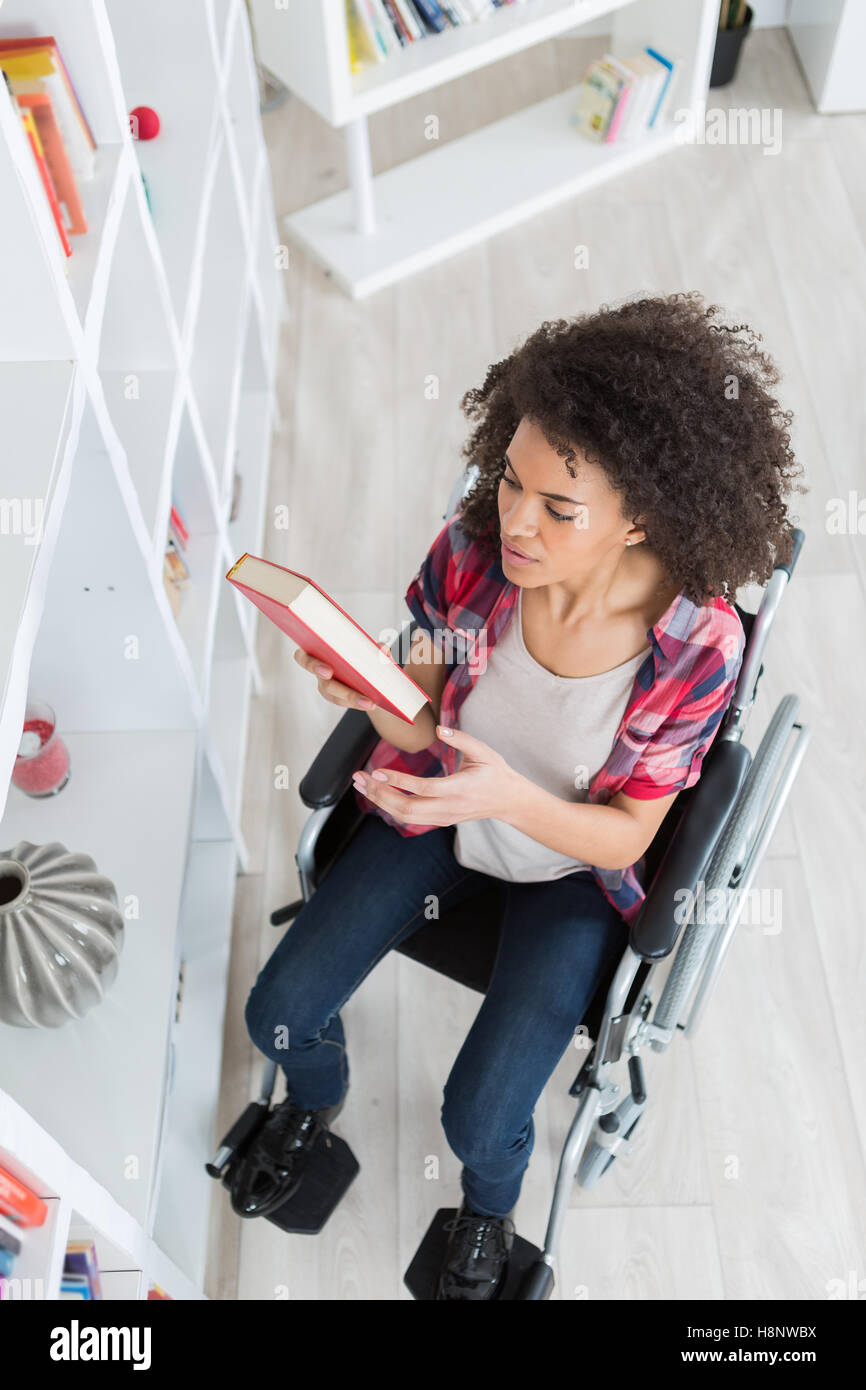 disabled student in library picking book at the university Stock Photo ...