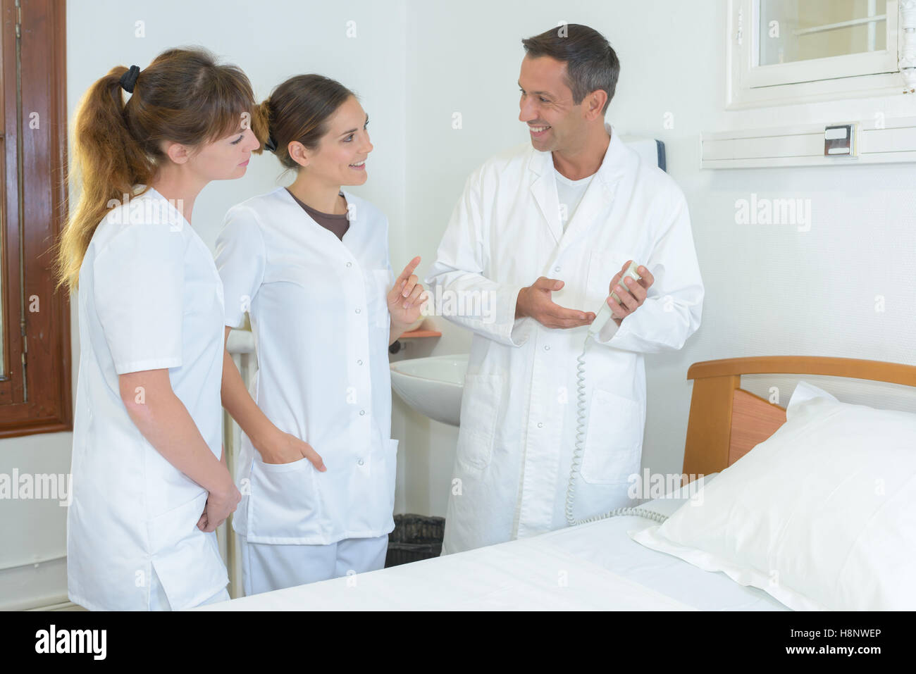 team of hospital employees in patients room Stock Photo - Alamy