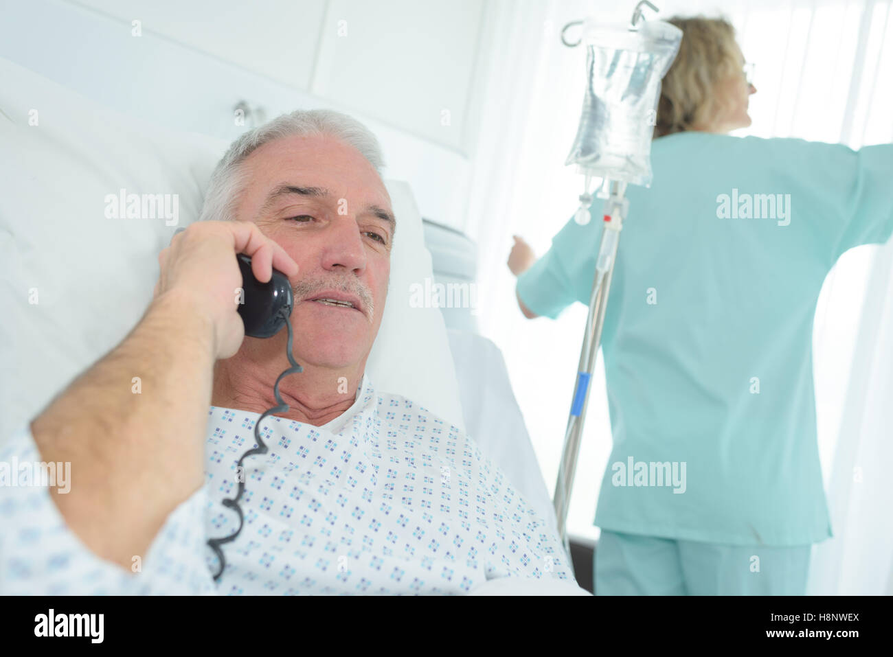 Male patient using phone hi-res stock photography and images - Alamy