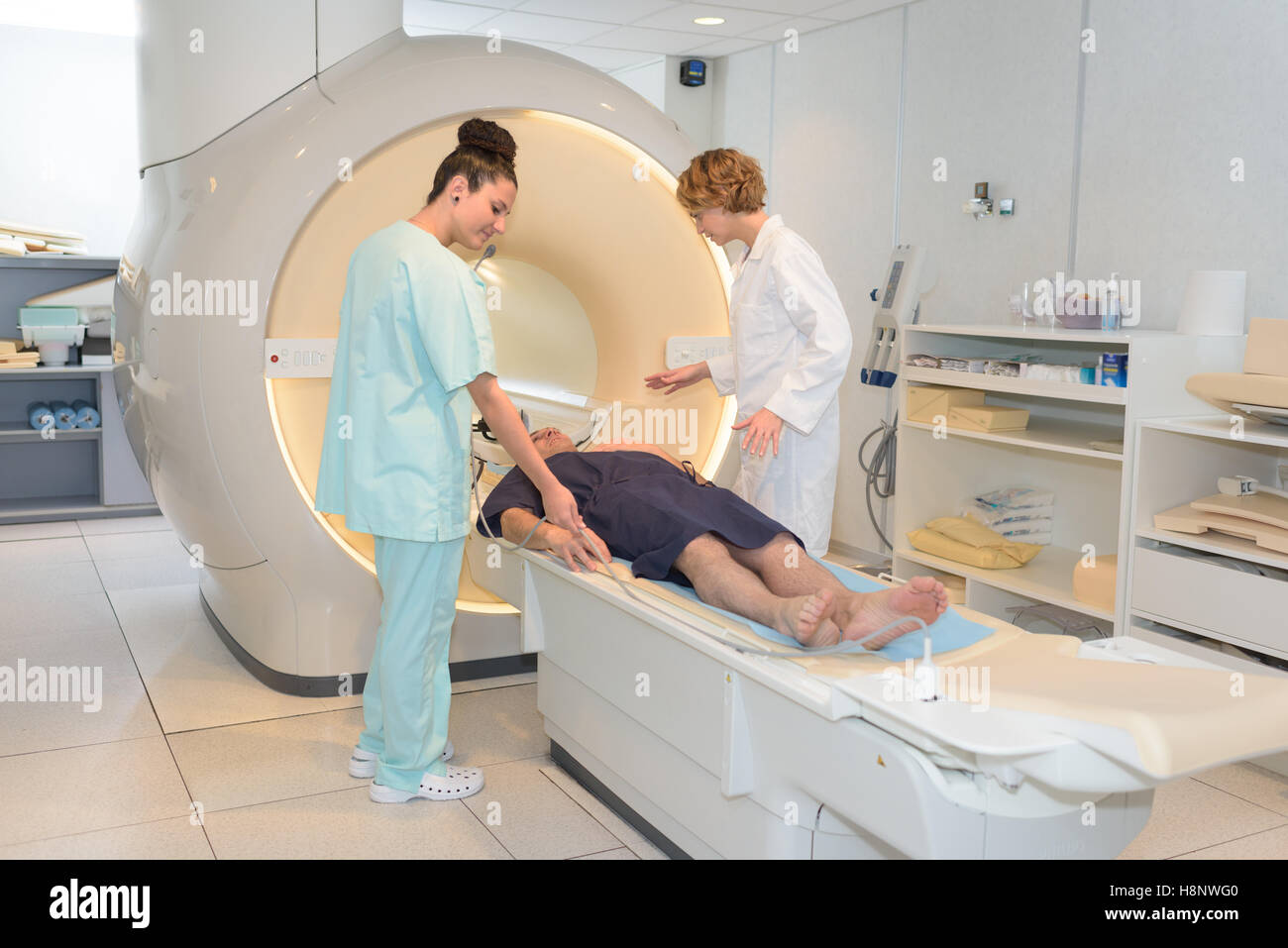 nurse and radiologist preparing patient for ct scan Stock Photo - Alamy