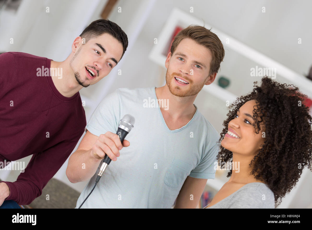 group of friends having fun karaoke singing at home Stock Photo - Alamy