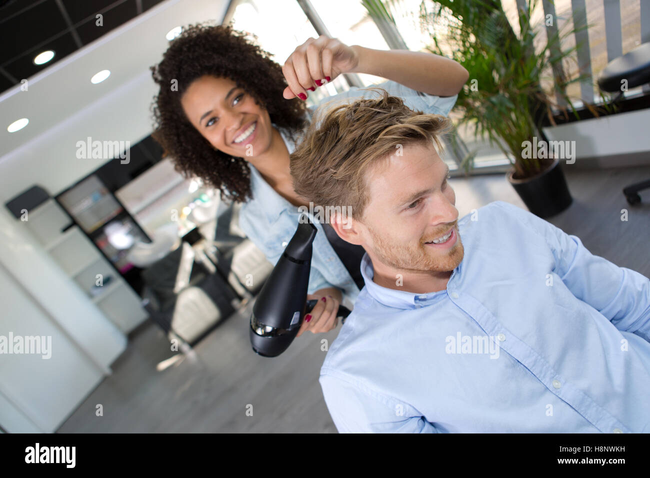 female hairstylist having fun with client Stock Photo - Alamy