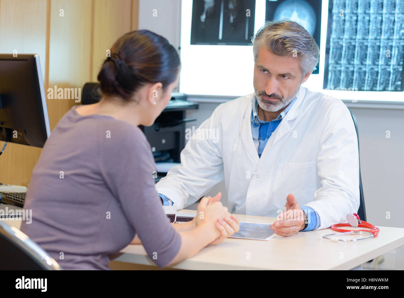 Doctor giving bad news to patient Stock Photo - Alamy