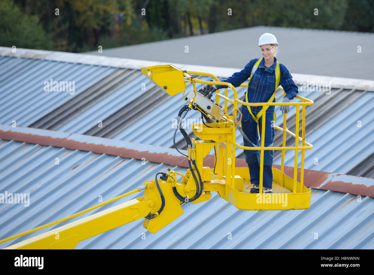 worker inspecting building roof Stock Photo - Alamy